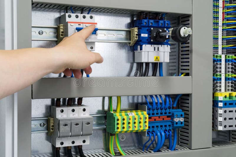 Hand Points Towards Switchboard or Control Cabinet - Electronics Stock ...