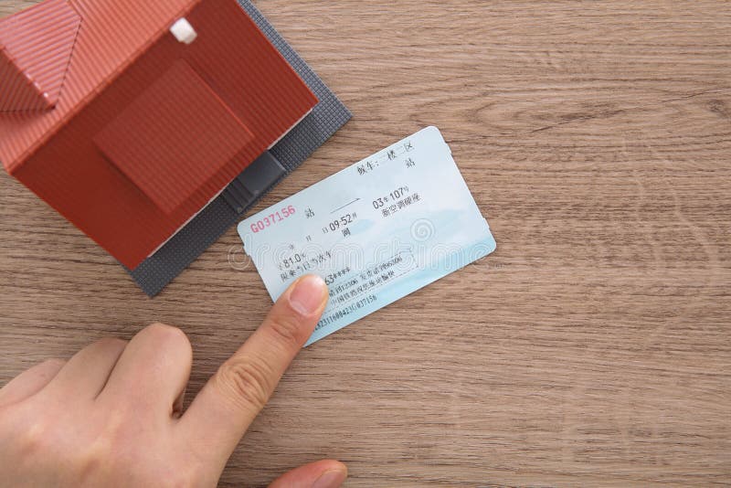 Hand Points a Train Ticket and a House Model Next To it Stock Image ...