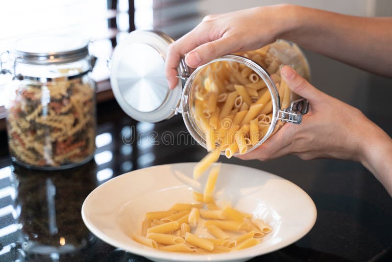 Hand Pour Pasta on White Dish in Kitchen Stock Image - Image of healthy ...
