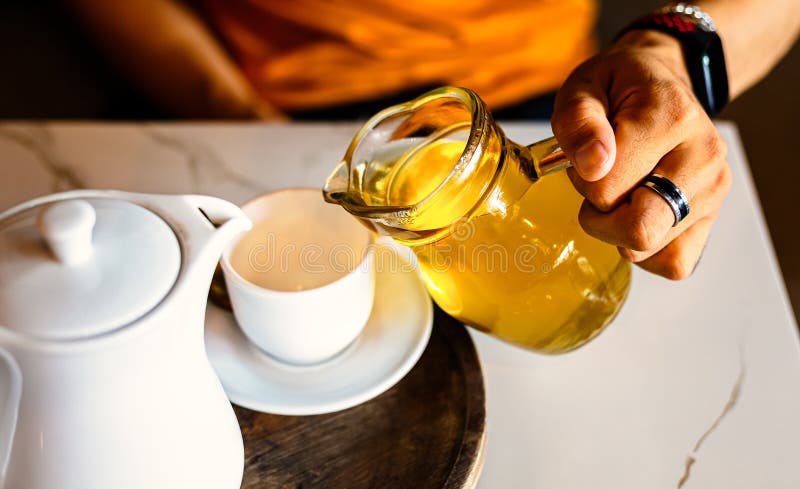 Hand Pour Tea in To Cup of Tea on the Table Stock Photo - Image of leaf ...