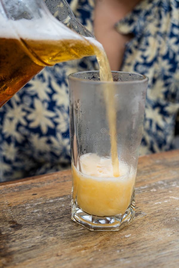 Hand Pouring a Cold Draught Beer from Glass Jar into a Glass Stock ...