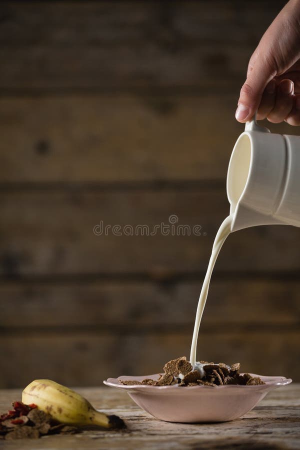 Hand Pouring Milk on Wheat Flakes Stock Photo - Image of healthy, flake ...