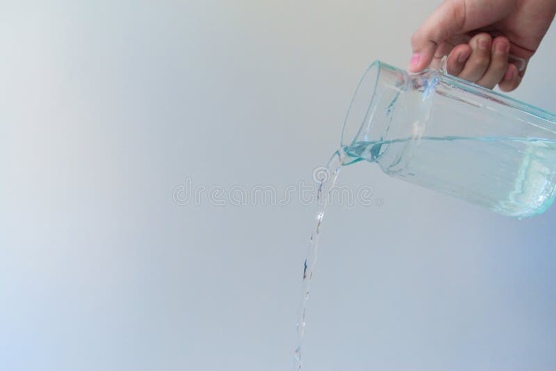 The Hand is Pouring Out of Jug Stock Image - Image of hand, hold: 303244187