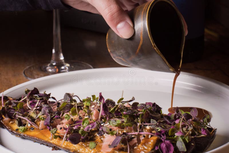 Hand Pouring Sauce on an Eggplant Dish Stock Image - Image of lunch ...