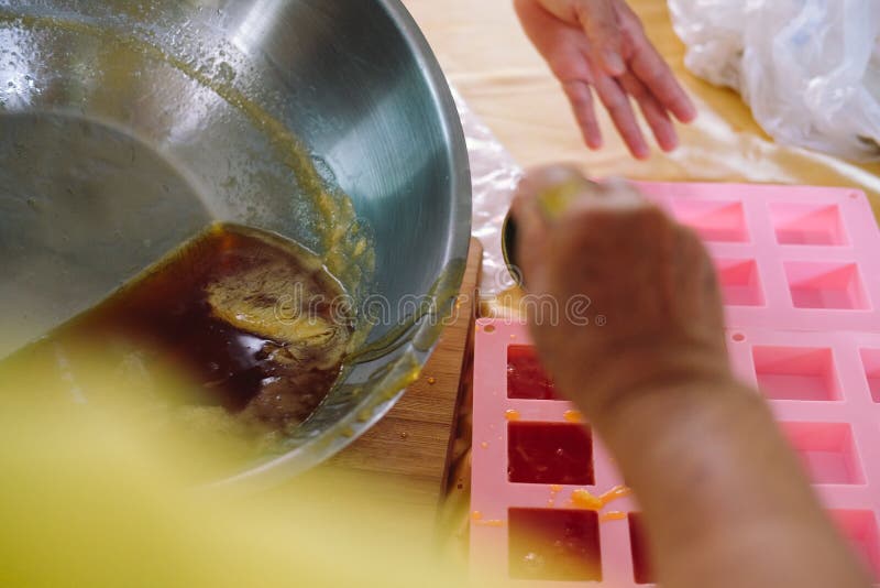 Hand Pouring Soap Mixture on Plastic Form Stock Photo - Image of ...