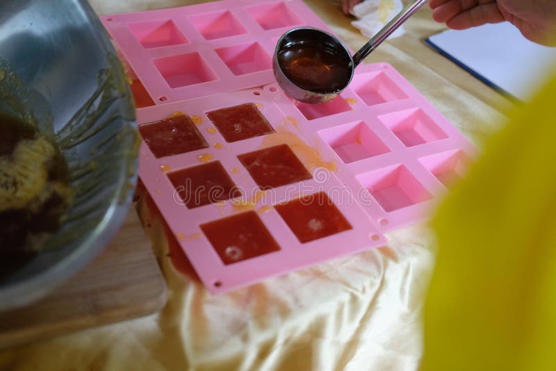 Hand Pouring Soap Mixture on Plastic Form Stock Photo - Image of ...