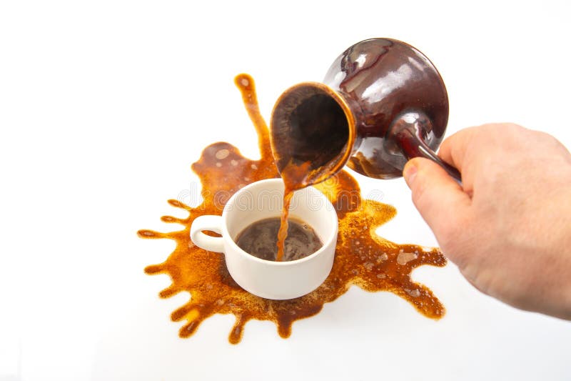 A Hand Pours Coffee from a Traditional Pot into a White Cup, Spilling ...