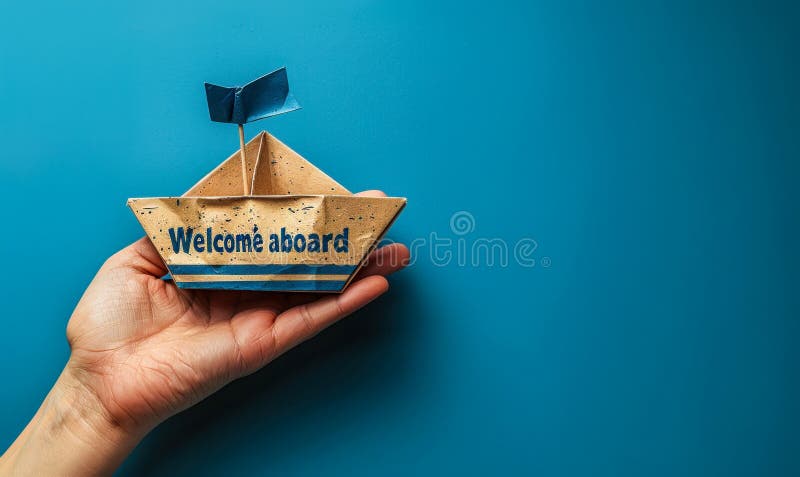 Hand Presenting a Paper Boat with the Message Welcome Aboard Against a ...