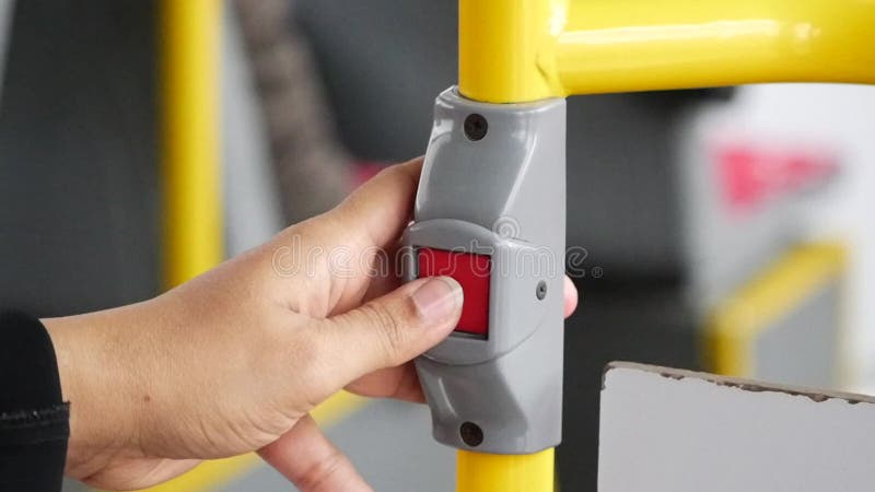 Using a Hand To Press a Button To Request a Stop for the Bus Service ...