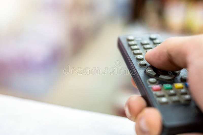 Hand Pressing Remote Control with Blur Scene Stock Image - Image of ...