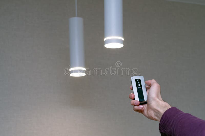 Hand Pressing a Remote Control Controlling an Light Stock Image - Image ...