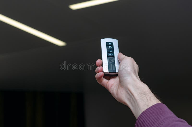 Hand Pressing a Remote Control Controlling an Light Stock Image - Image ...