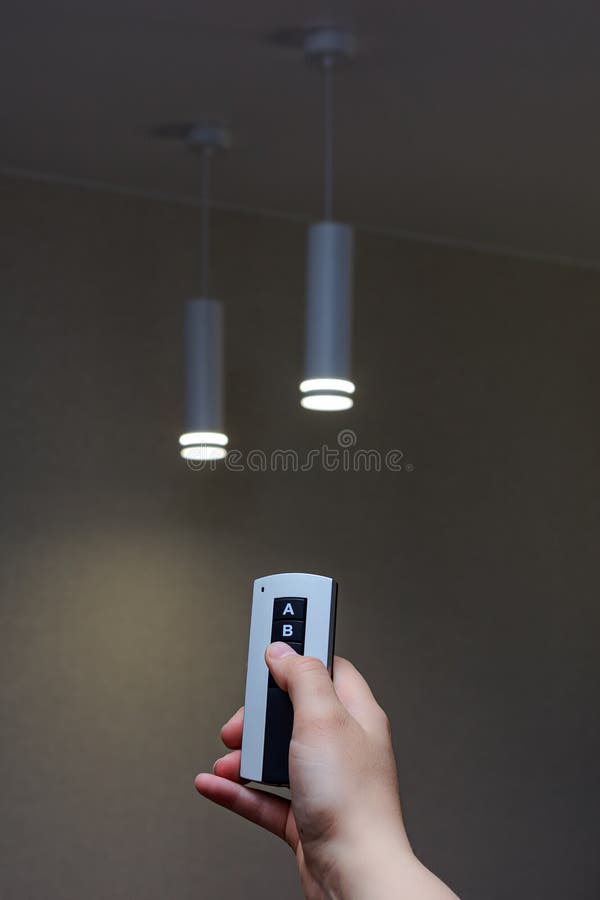 Hand Pressing a Remote Control Controlling an Light Stock Image - Image ...