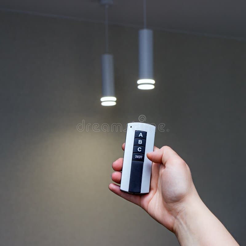 Hand Pressing a Remote Control Controlling an Light Stock Image - Image ...