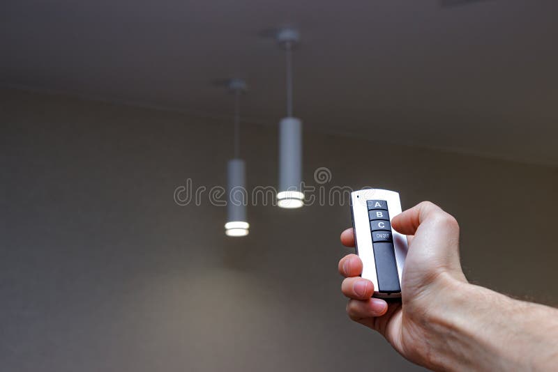 Hand Pressing a Remote Control Controlling an Light Stock Image - Image ...