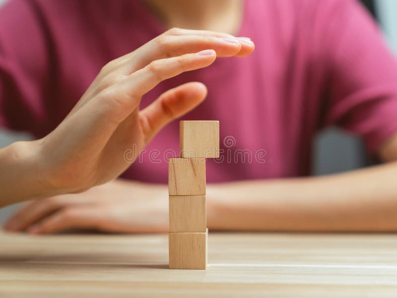 Hand Preventing Falling Wooden Blocks Stock Image - Image of block ...