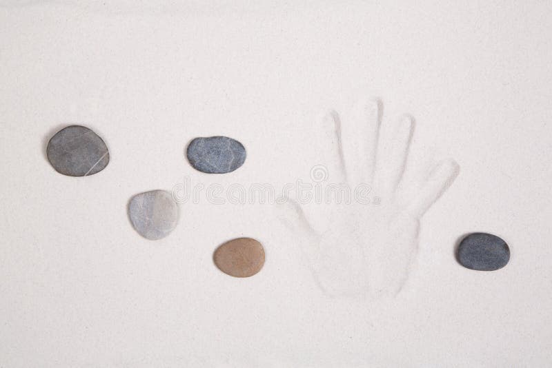 Hand Print in the Sand with Five Stones for Meditation Concepts. Stock ...