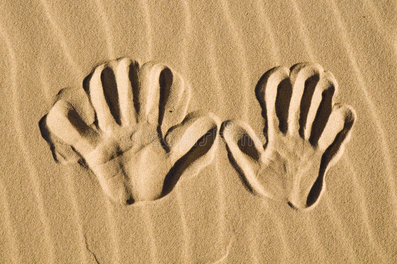 Hand prints in the sand stock image. Image of tourism - 6455005