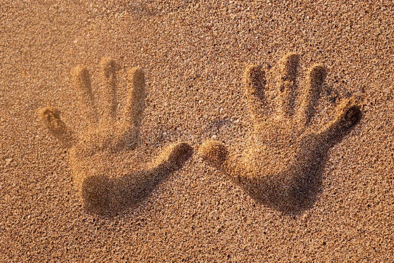 Hand prints on the sand stock image. Image of human, coast - 95004589