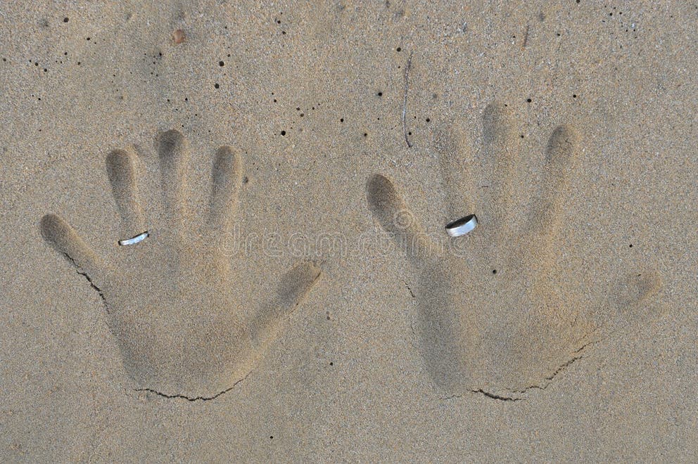 Hand Prints with Wedding Bands on Beach Sand Stock Photo - Image of ...
