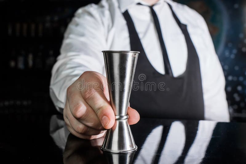 The Hand of a Professional Bartender Holds a Jigger Tool or Measuring ...