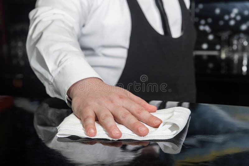 The Hand of a Professional Bartender Wipes the Bar Counter with a ...