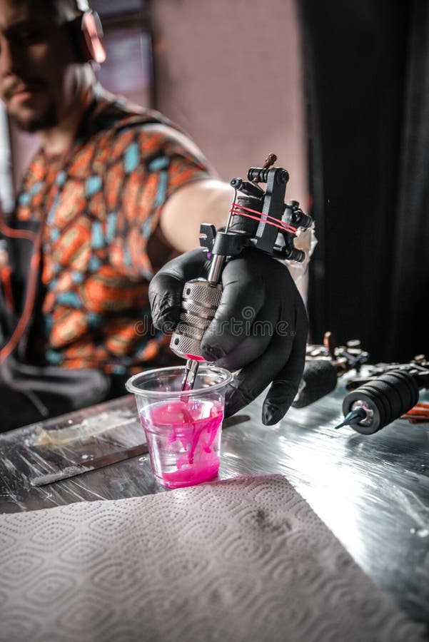 Hand of Professional Tattoo Artist and a Tattoo Gun. Stock Photo ... Hand of Professional Tattoo Artist and a Tattoo Gun. Stock Photo ...