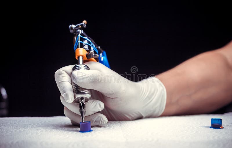Hand of a Tattoo Specialist and a Tattoo Machine. Stock Photo - Image ...