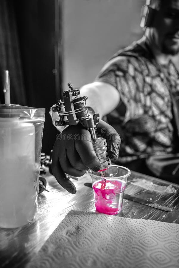 Hand of Professional Tattooist and a Tattoo Machine. Stock Image ...