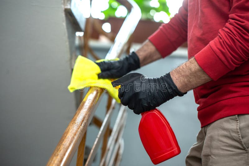Hand in Protective Rubber Gloves with a Sterilizing Cleaning Solution ...