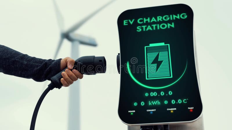 Hand Pull EV Charger from EV Car Charging Station at Wind Turbine ...