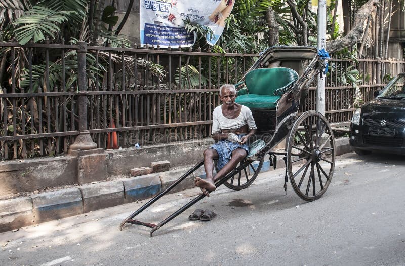 A Hand Pulled Rickshaw with Rickshaw Puller in the Street. Editorial ...