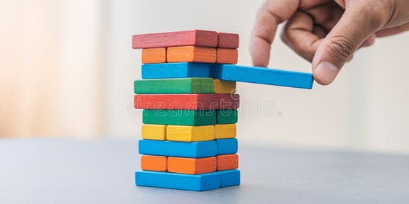 Hand Pulling Blue Block from Multicolored Jenga Tower Stock ...