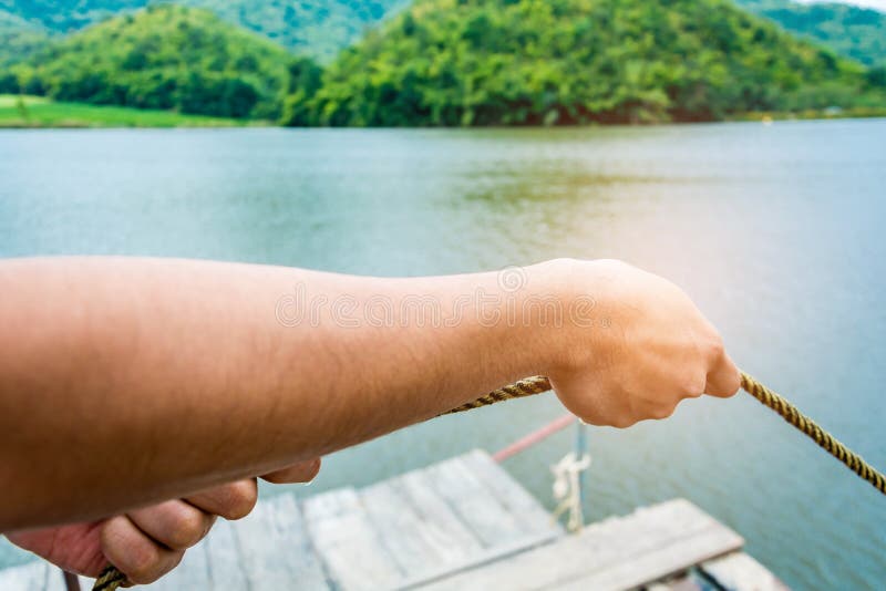 Hand pulling a rope white stock image. Image of environment - 84232457
