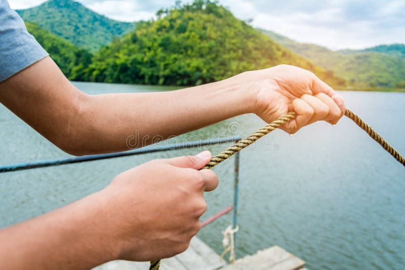 Hand pulling a rope white stock image. Image of nature - 84234383