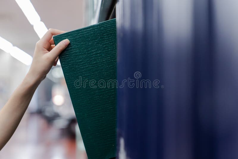 Hand Pulling A Thesis Book Off The Shelf In Library. Green Colors Books ...