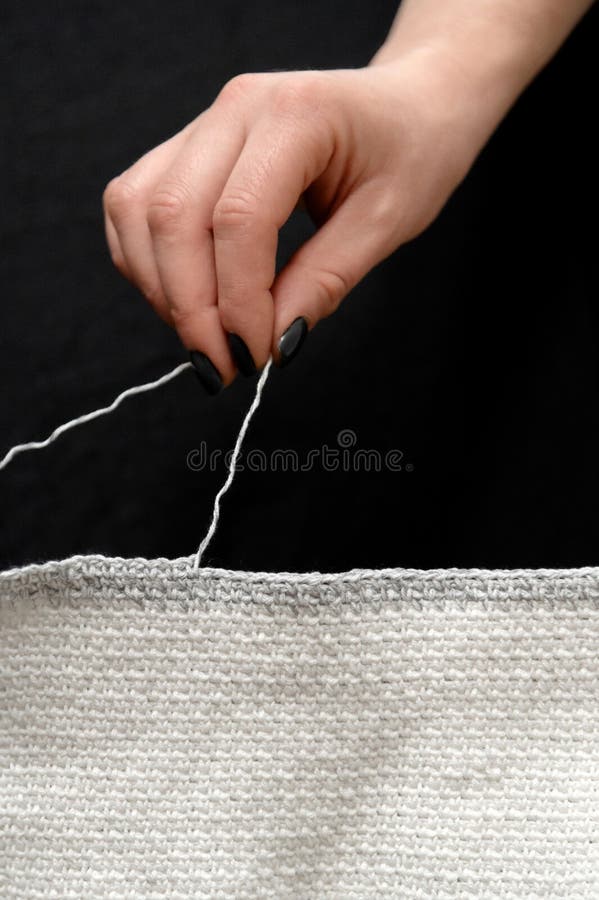 A Hand Pulling a Thread and Tearing a Knitted Thing. the Concept of ...