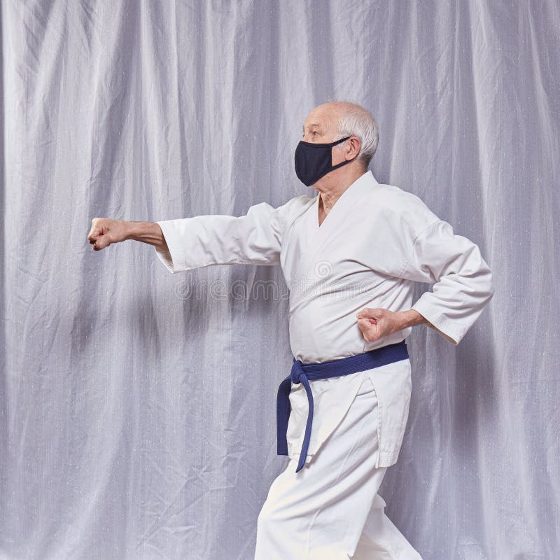 Hand Punch Performed by an Athlete in a Black Medical Mask Stock Image ...