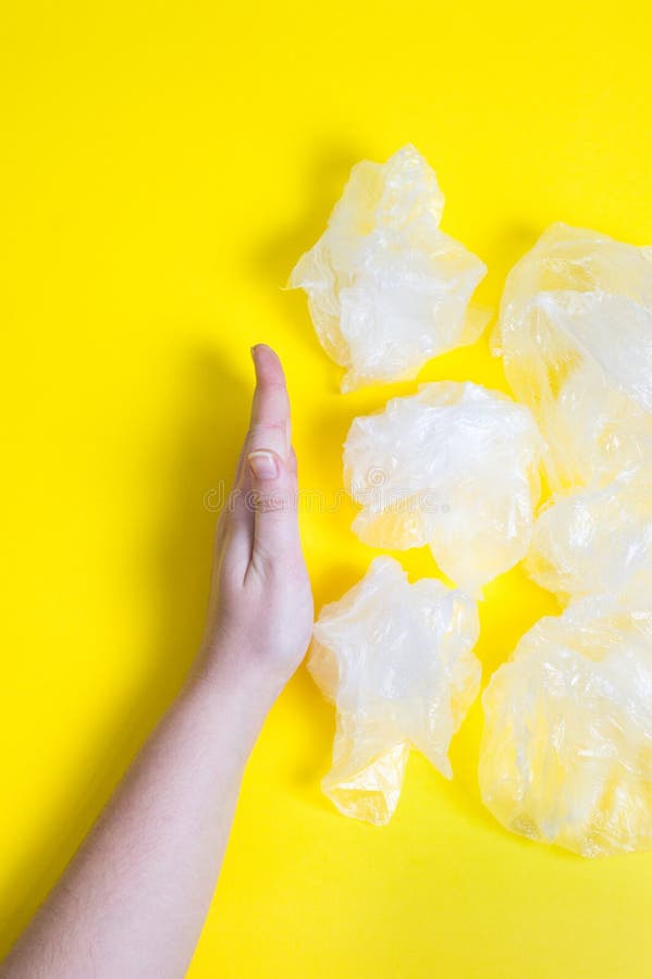 Hand Pushes Away Plastic Bags on Yellow Background Stock Image - Image ...