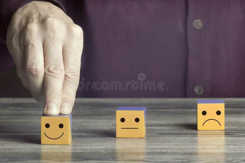 The Hand Pushes Forward a Yellow Cube in the Form of a Smiley Face ...