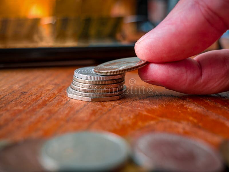 Hand Put Coins To Stack of Coins. a Pile of Coins in the Foreground ...