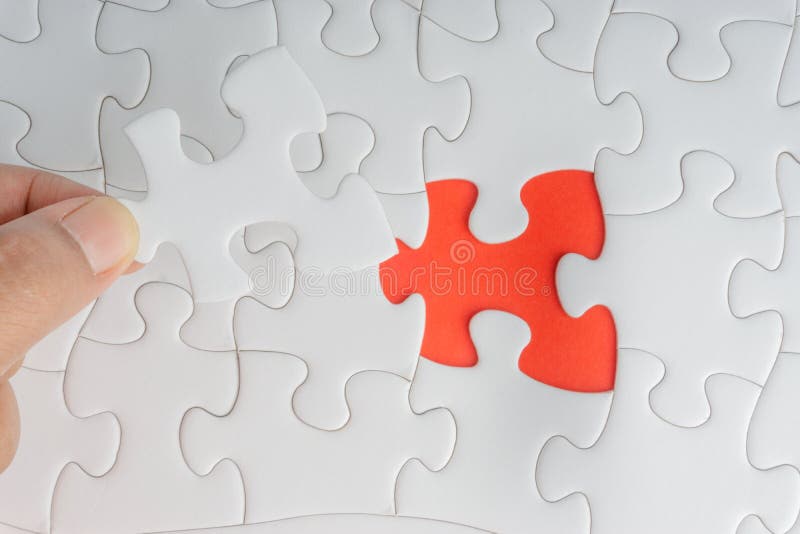 Hand Put the Last Piece of Jigsaw Puzzle Closeup To Complete the ... Hand Put the Last Piece of Jigsaw Puzzle Closeup To Complete the ...