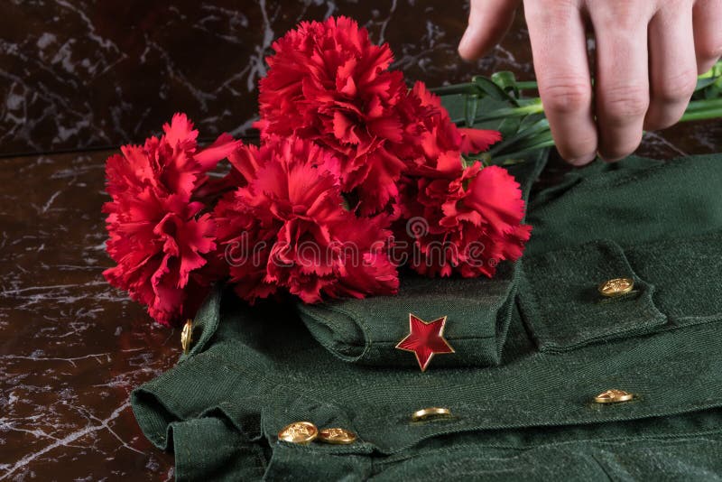 Hand Put the Red Flowers on the Military Uniform Stock Image - Image of ...