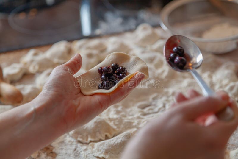 Hand Puts Berries in Dumpling Spoon Stock Image - Image of marble, lies ...