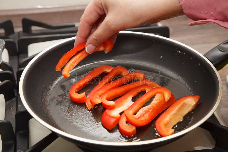 Hand Puts Sliced Bell Peppers in the Frying Pan Stock Photo - Image of ...