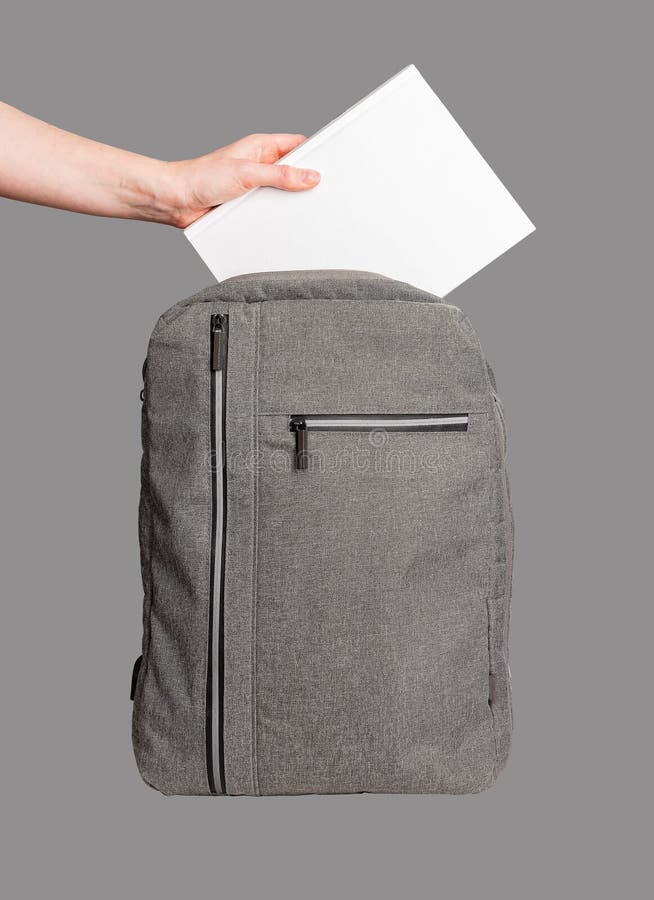 Hand Putting Blank Book into Backpack Stock Photo - Image of book ...