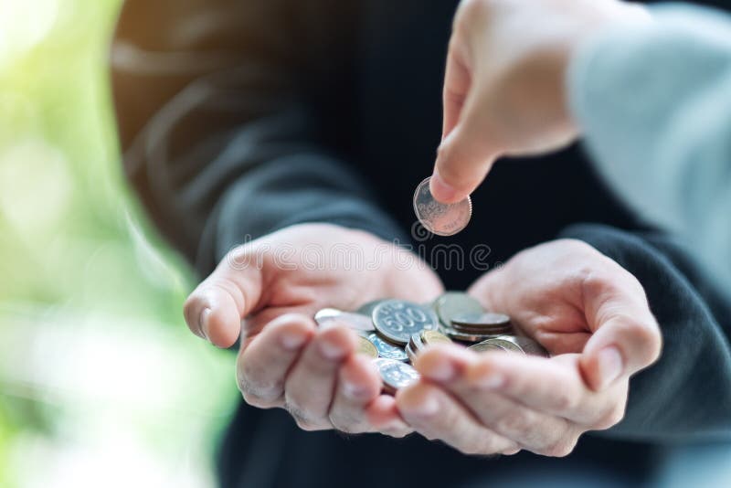 A Hand Putting Coins into Another People`s Hands Stock Photo - Image of ...