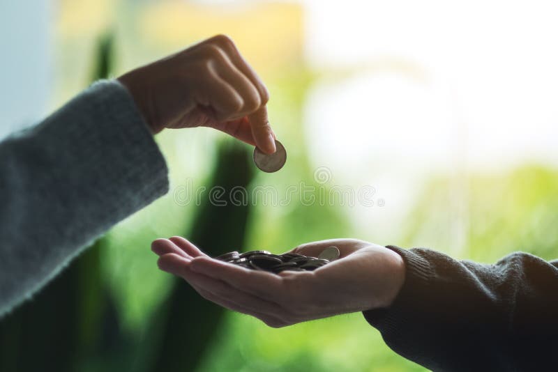 A Hand Putting Coins into Another People`s Hands Stock Image - Image of ...