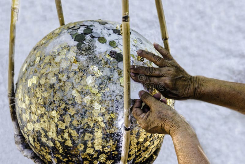 Hand Putting Gold Leaf on Boundary Stone Stock Photo - Image of ...