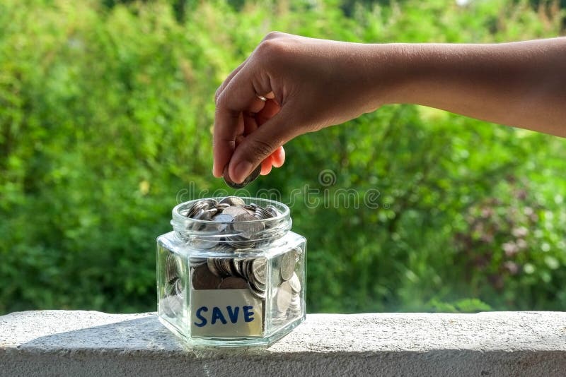 Hand putting money coins stock photo. Image of estate - 61383258